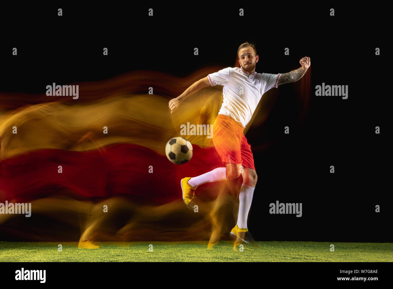 Burn. Young caucasian male football or soccer player in sportwear and ...