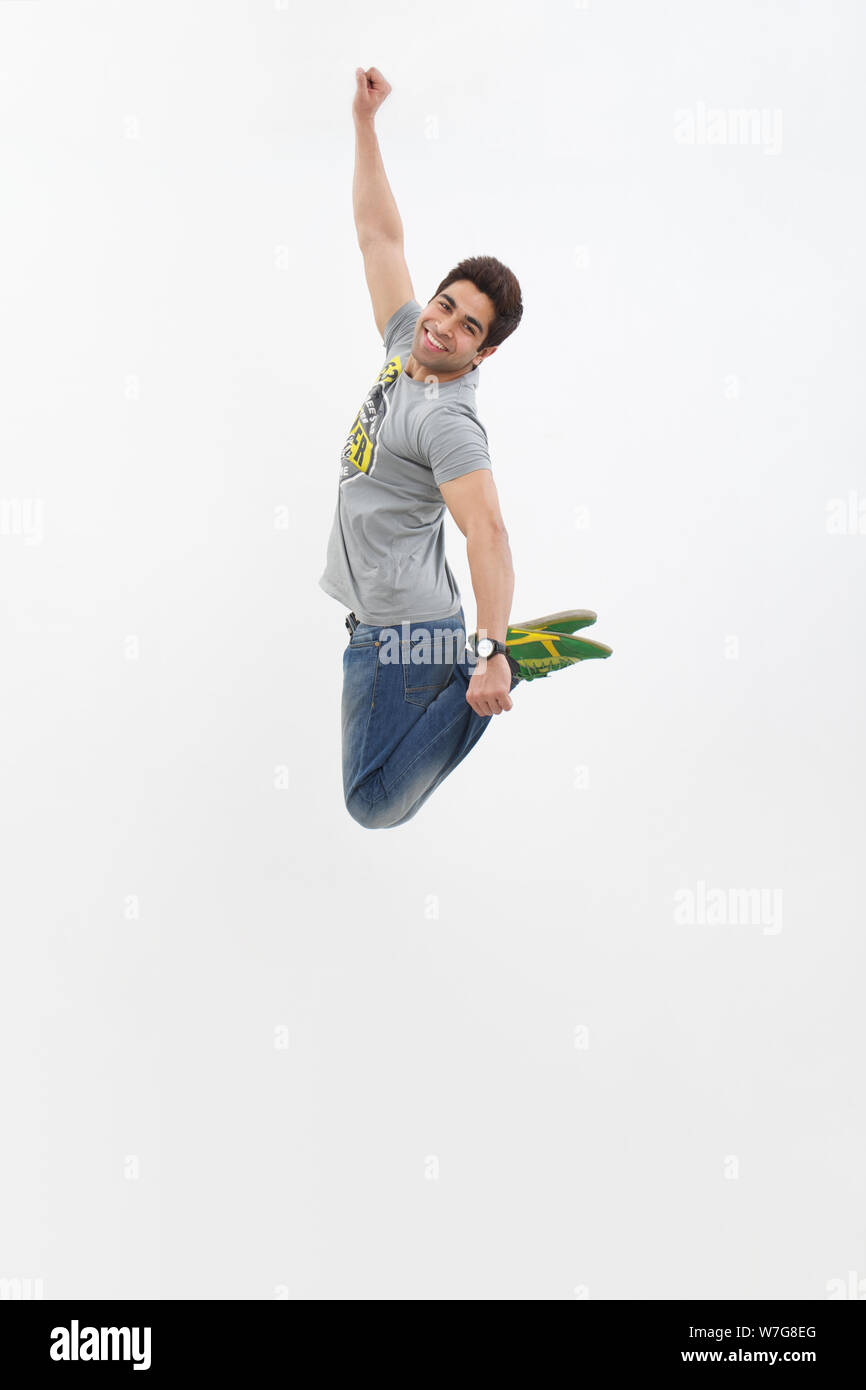Young man jumping in mid air Stock Photo - Alamy