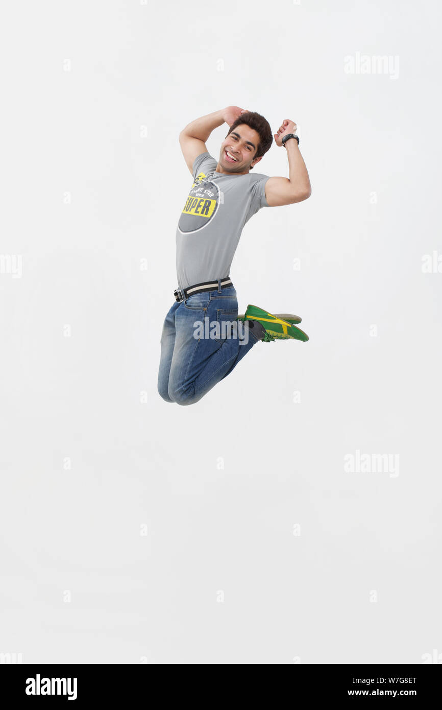 Young man jumping in mid air Stock Photo - Alamy