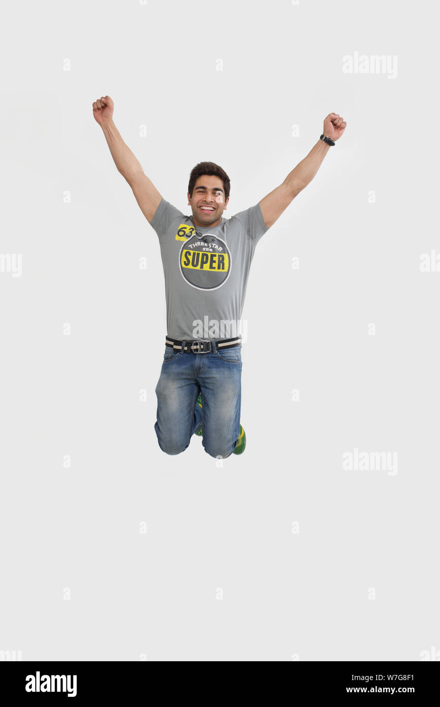 Young man jumping in mid air Stock Photo - Alamy