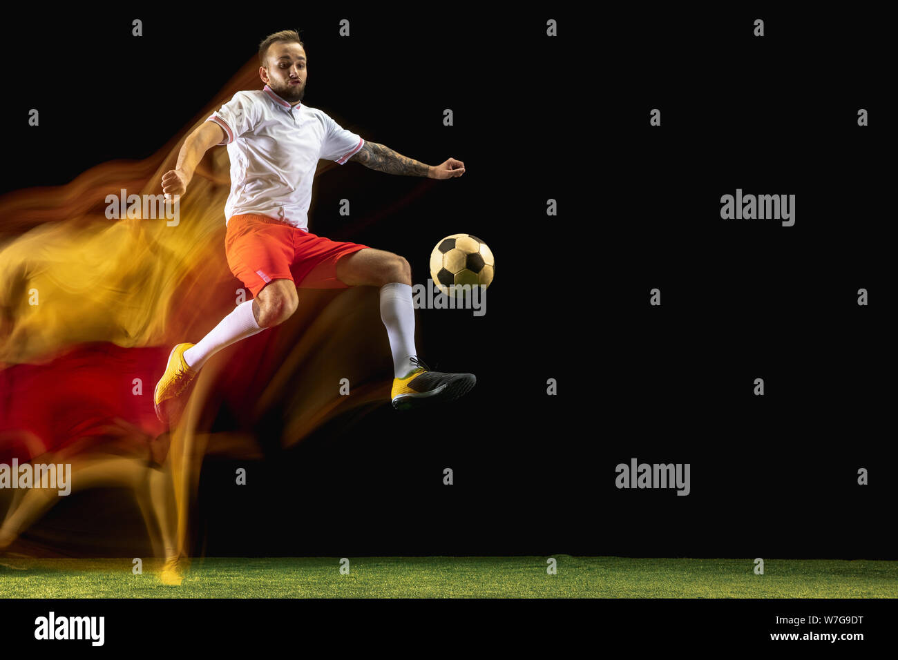 Self-build. Young caucasian male football or soccer player in sportwear ...