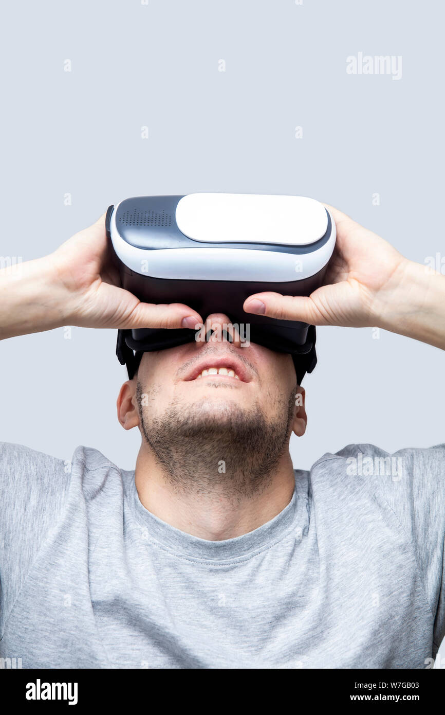 Young man using vr headset in studio, experiencing virtual reality ...