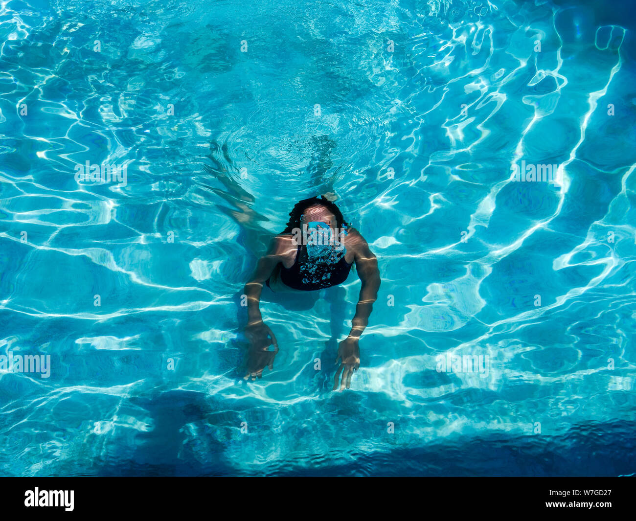 Woman diving into pool splash hi-res stock photography and images - Alamy