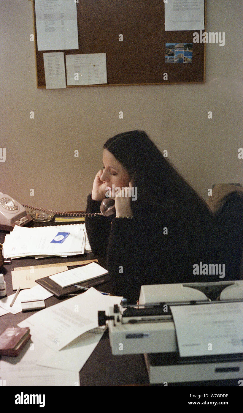 1970s, historical, female office worker at her desk on the telephone ...