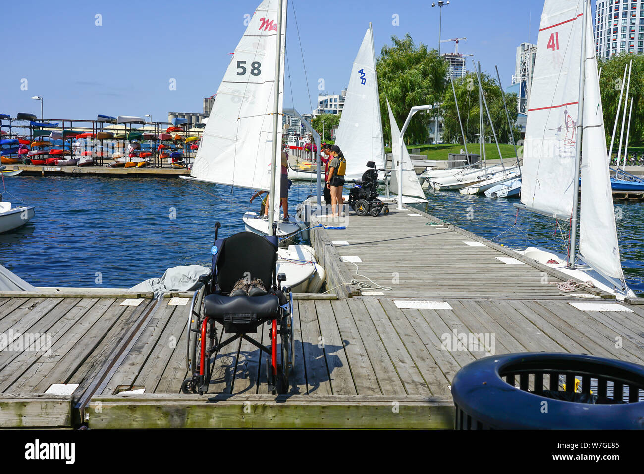 Disabled young kids are introduced to sailing, sailing instructor helps ...