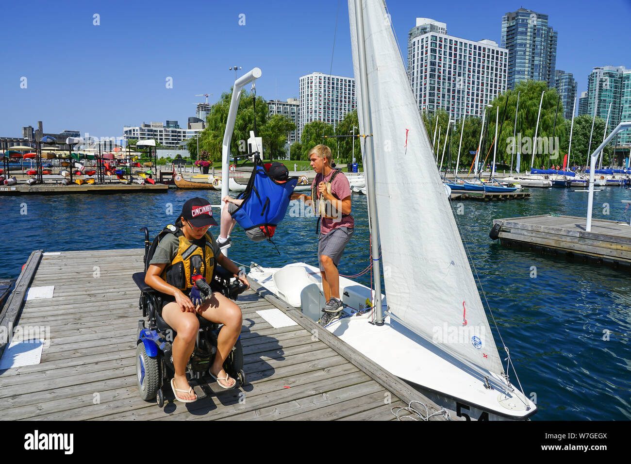Disabled young kids are introduced to sailing, sailing instructor helps ...
