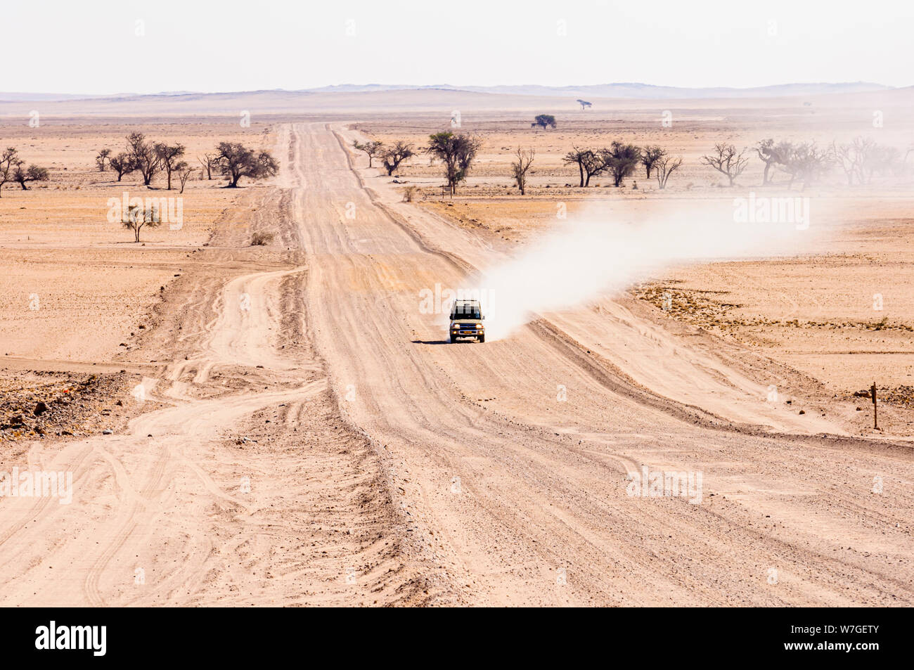 Toyota Hilux pick-up truck creates a dust cloud as it dives through the ...