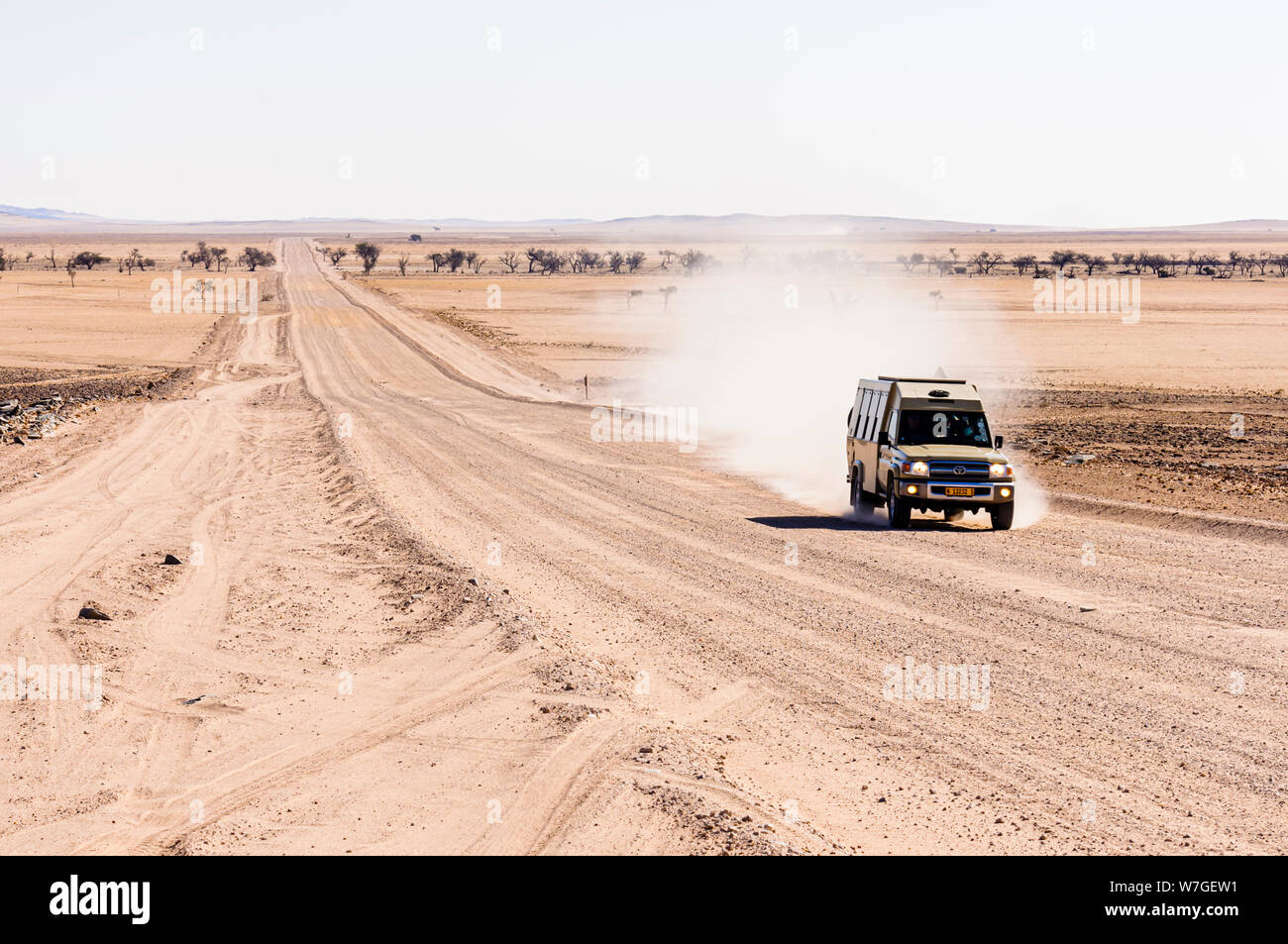 Toyota Hilux pick-up truck creates a dust cloud as it dives through the ...