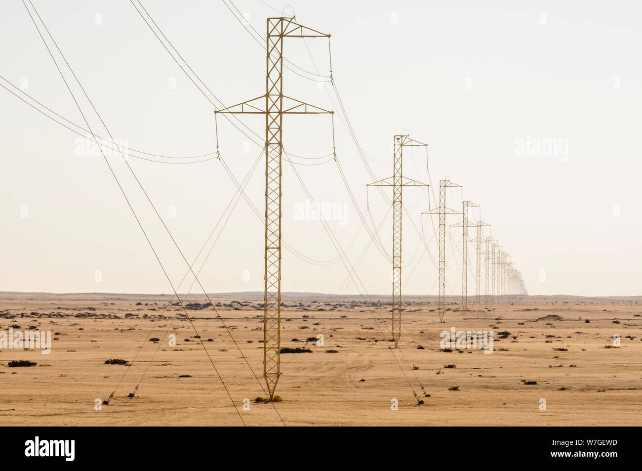 Electricity pylons stretch out as far as you can see, showing the ...