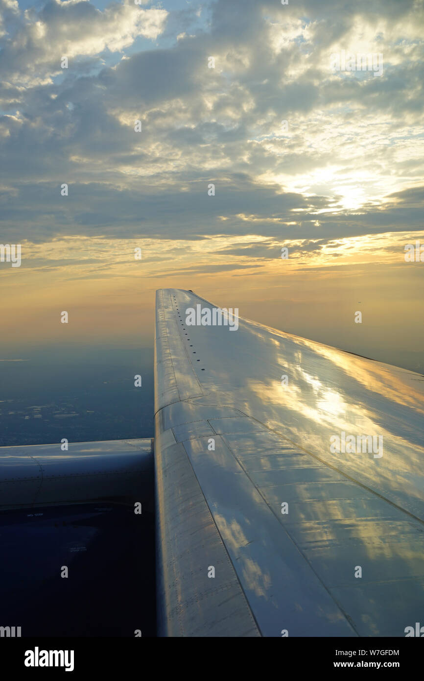 View of an airplane wing in the sky at sunset Stock Photo - Alamy