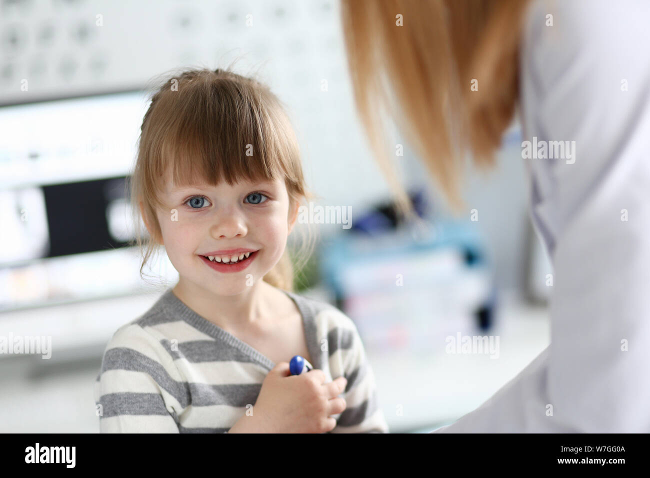 Smiling little patient having doctors appointment Stock Photo - Alamy