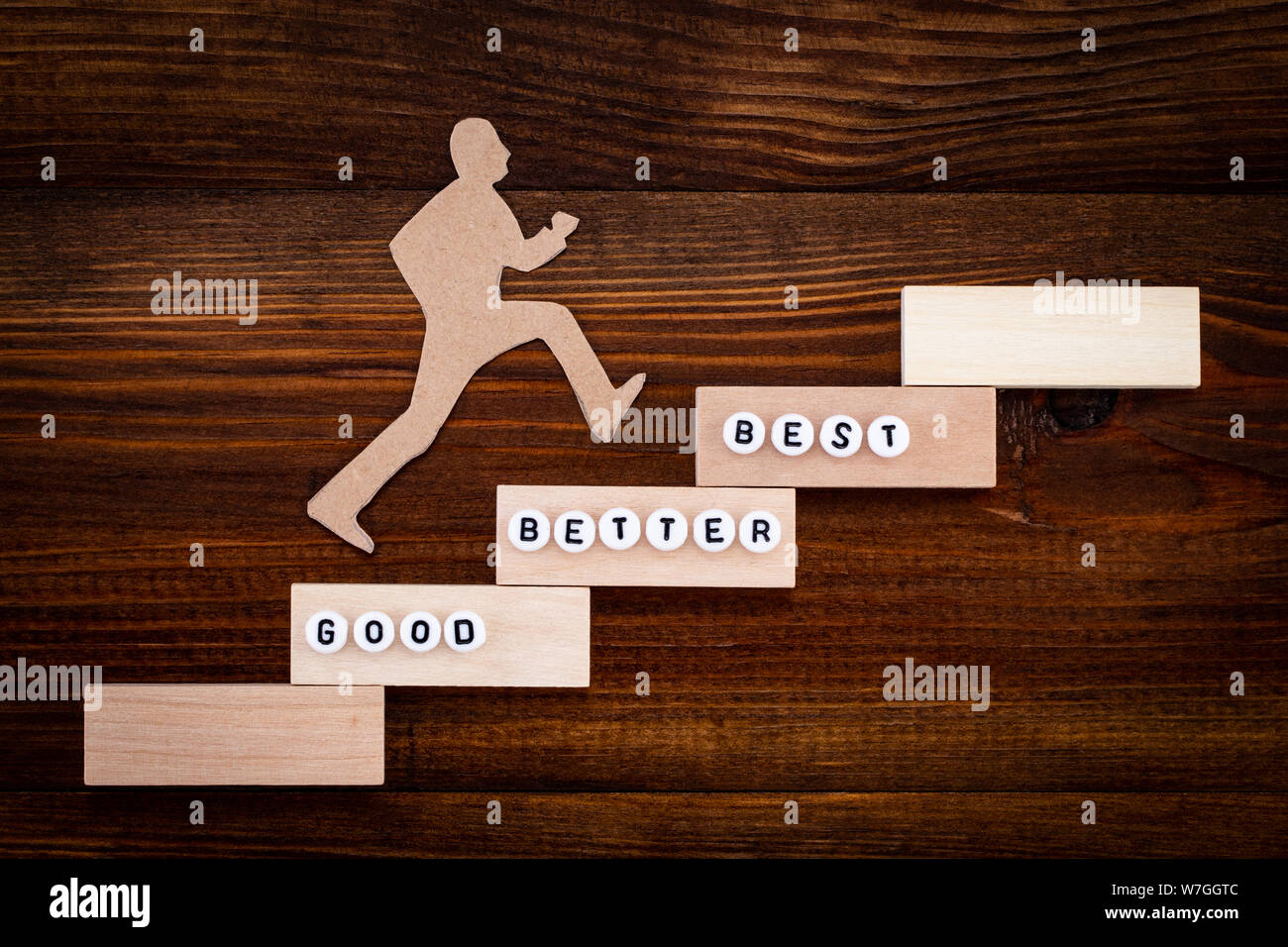 Good - Better - Best, paper man climbing the steps to success in a ...