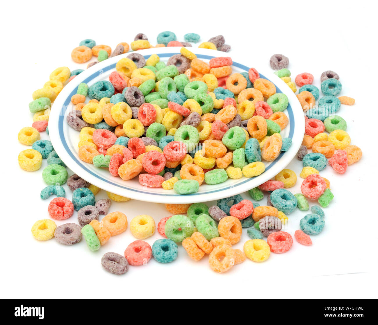 a pile or colorful cereal on dish on white background Stock Photo - Alamy