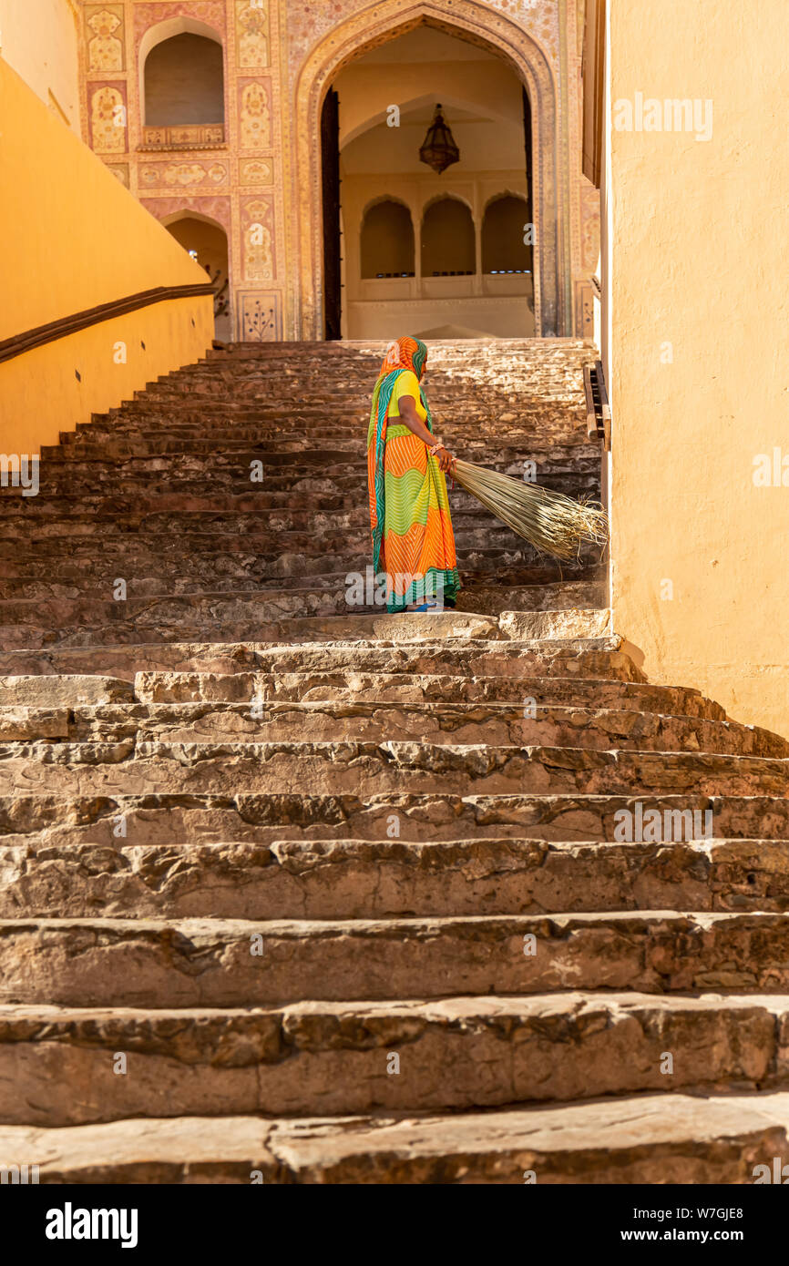 Lady sweeping stone steps with reed brush Stock Photo - Alamy