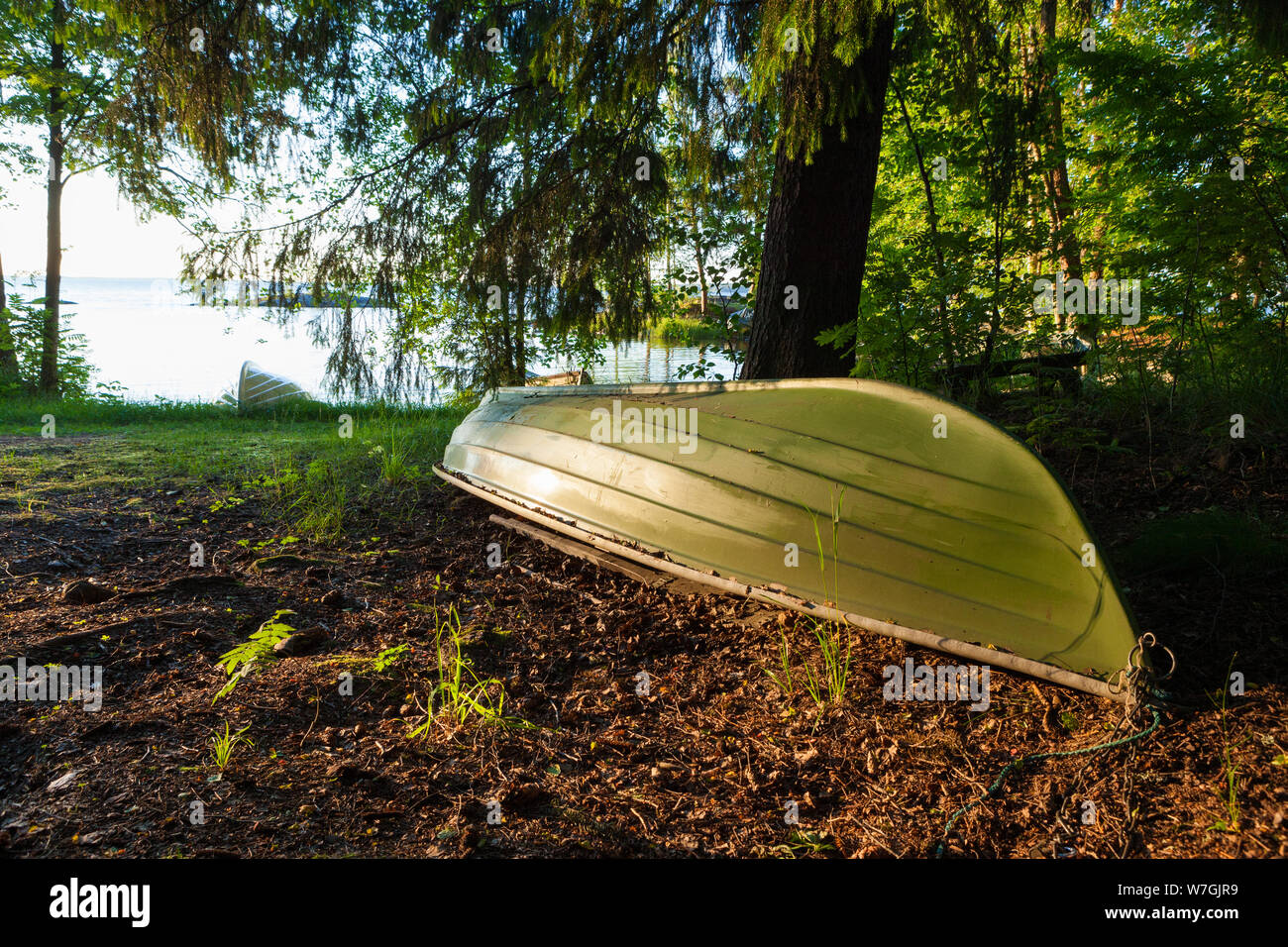 Rowing boat on storage at lake shore summer day Stock Photo - Alamy