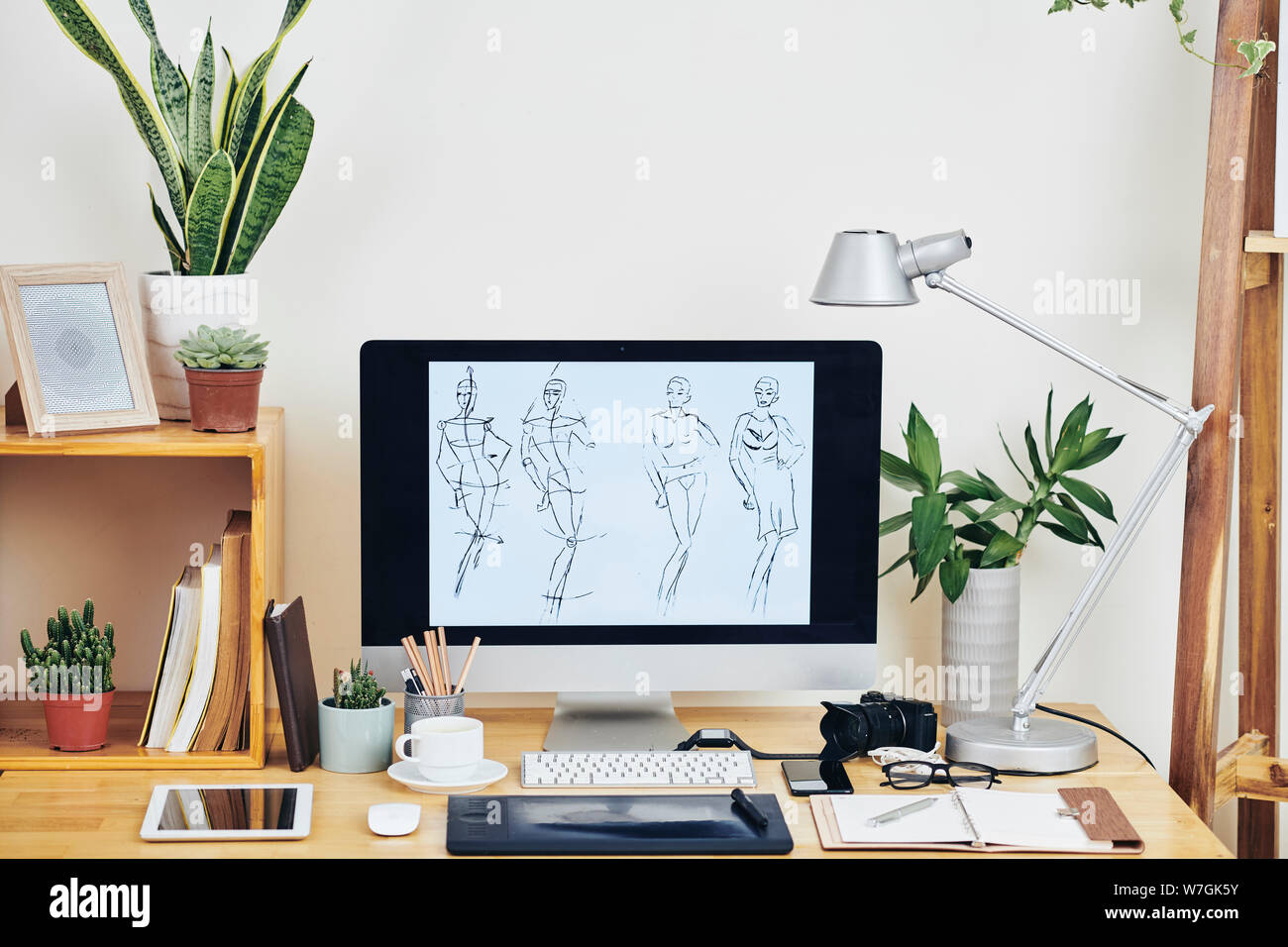 Workplace of illustrator with line female figures on computer screen ...