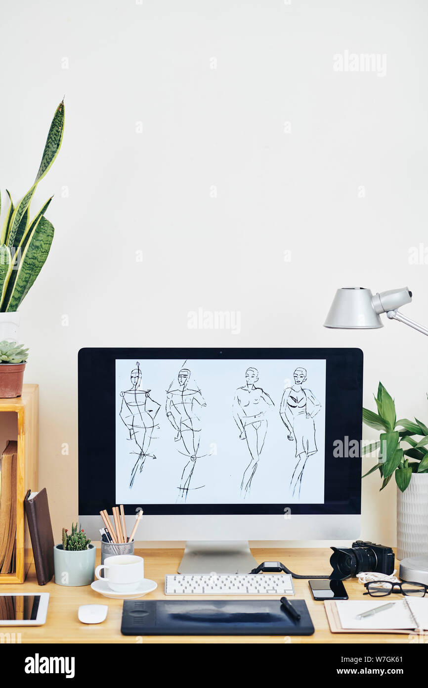 Line sketches of female figure in various clothes on screen of computer ...