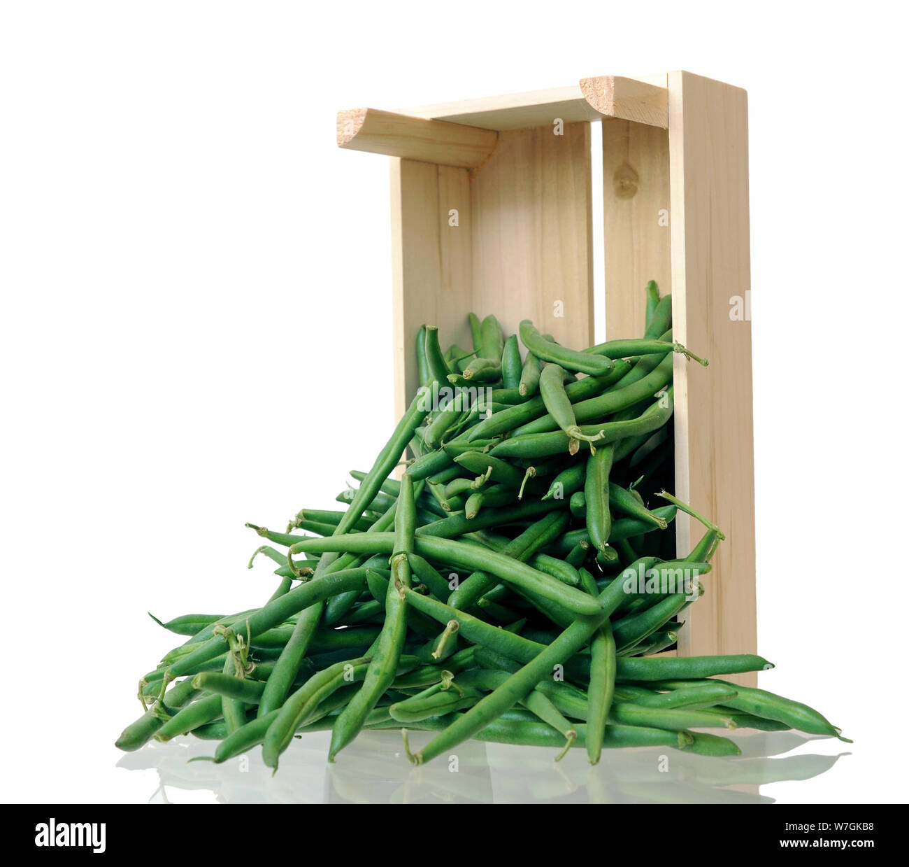 green beans fall off from crate on white background Stock Photo - Alamy