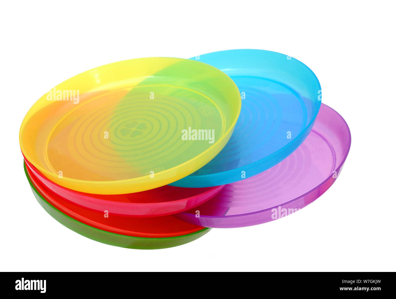 some colorful neon plastic dishes on white Stock Photo - Alamy