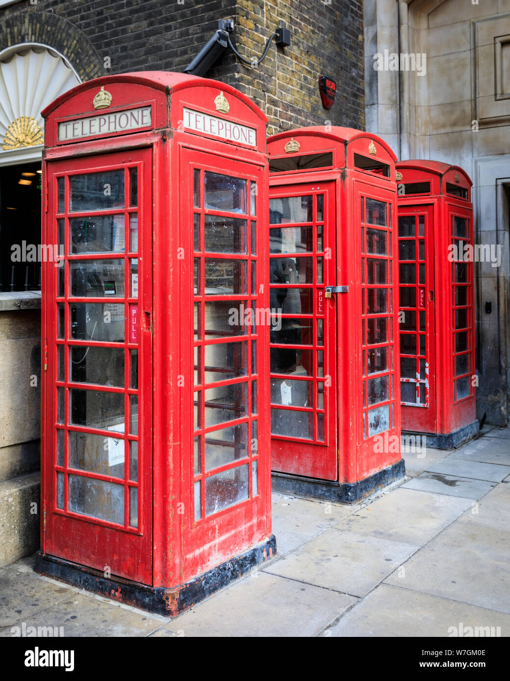 Three iconic traditional red British telephone boxes in London, England ...
