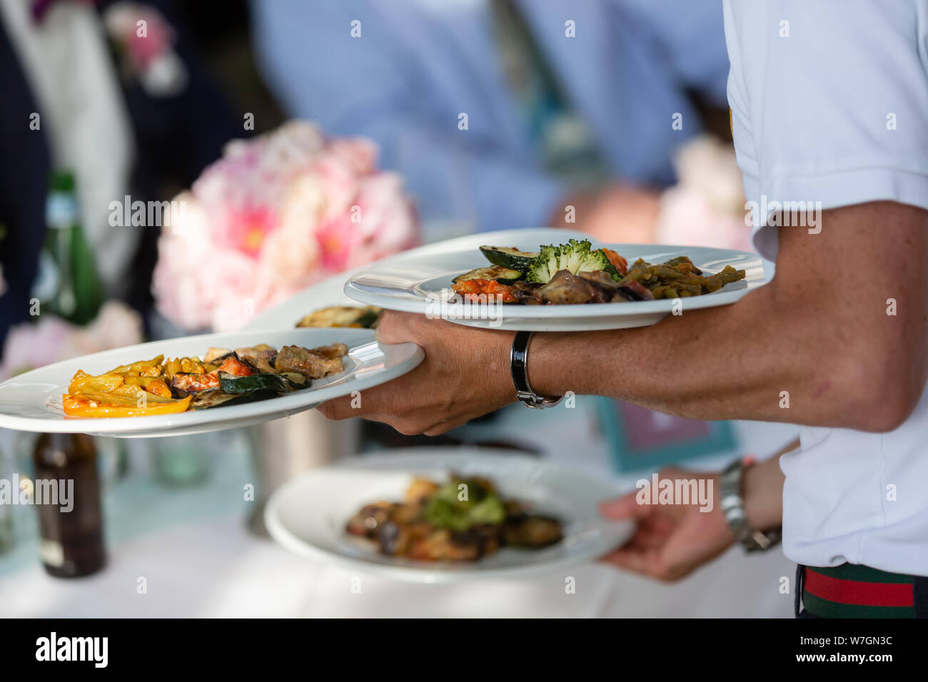 picture of a waiter who serves Italian antipasti in an outdoor ...
