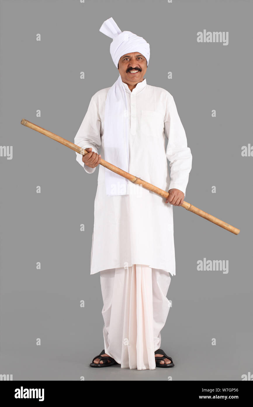 Rural man standing with his cane Stock Photo - Alamy