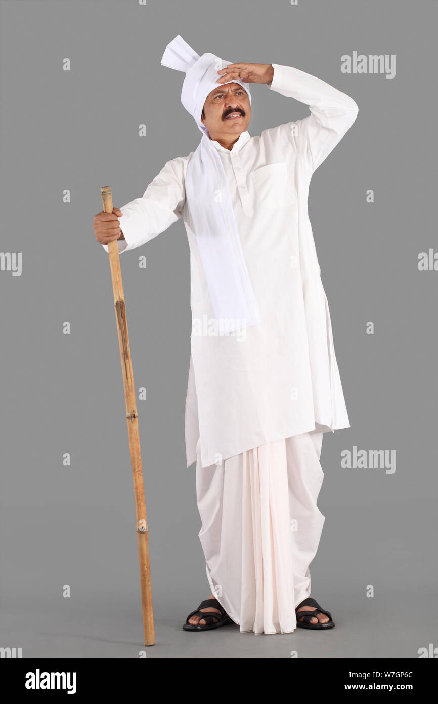 Rural man standing with his cane Stock Photo - Alamy