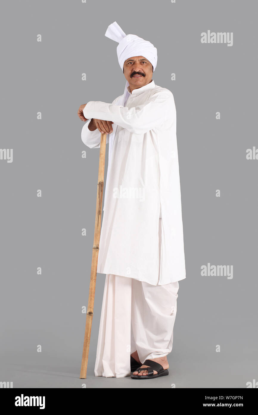 Rural man standing with his cane Stock Photo - Alamy