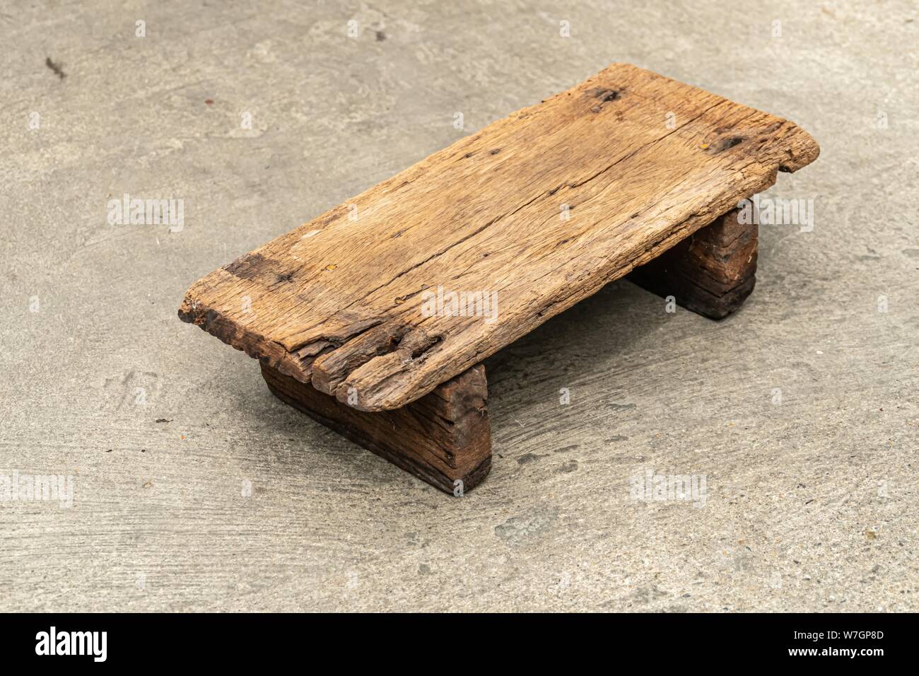 Outdoor very low chair made from old wooden Stock Photo - Alamy