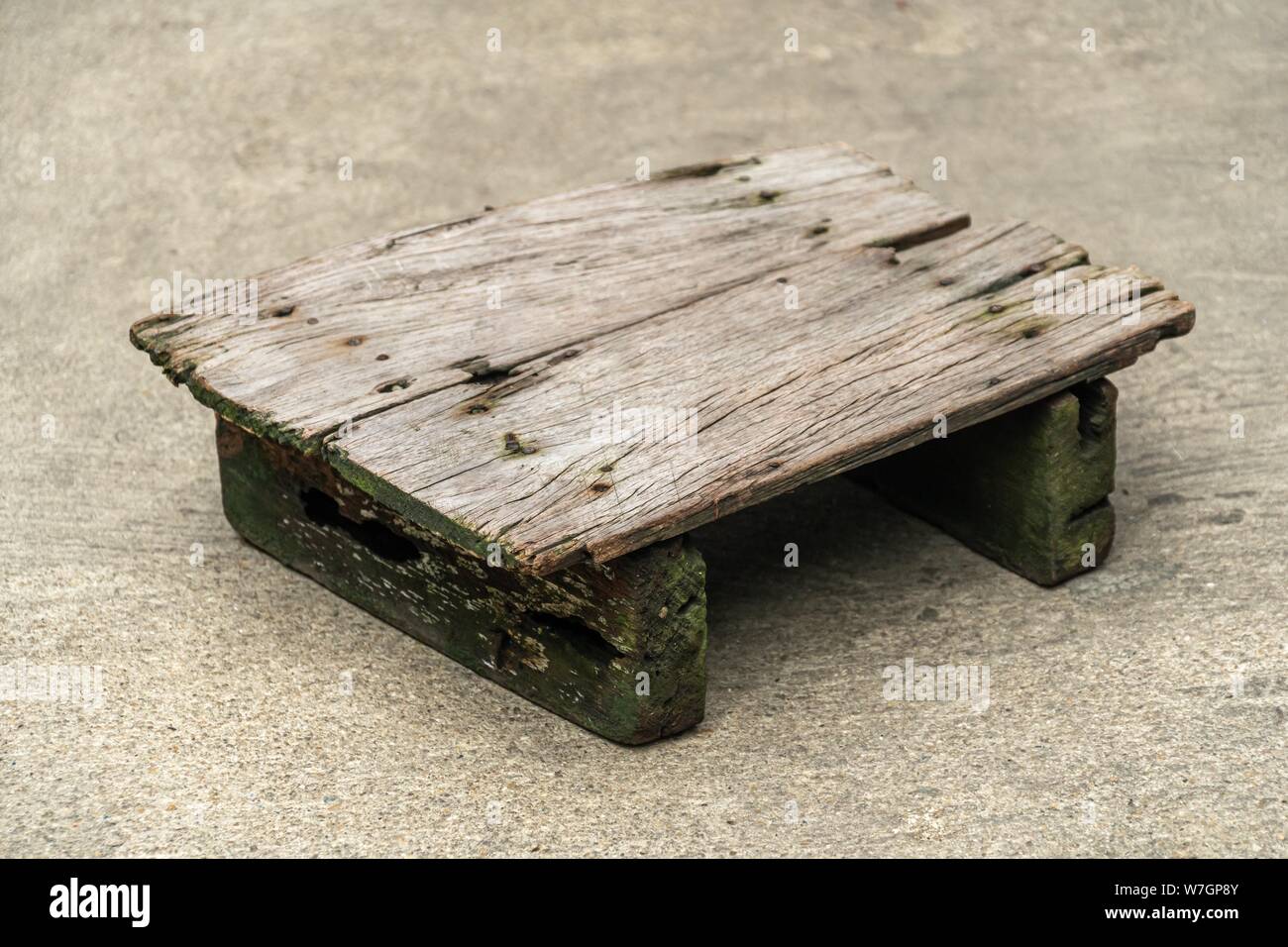 Outdoor very low chair made from old wooden Stock Photo - Alamy