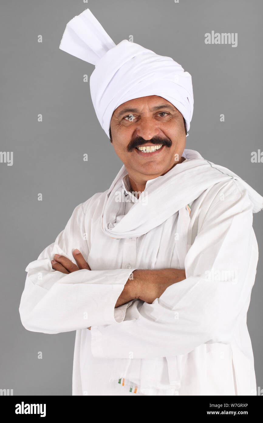 Rural man smiling with his arms crossed Stock Photo - Alamy