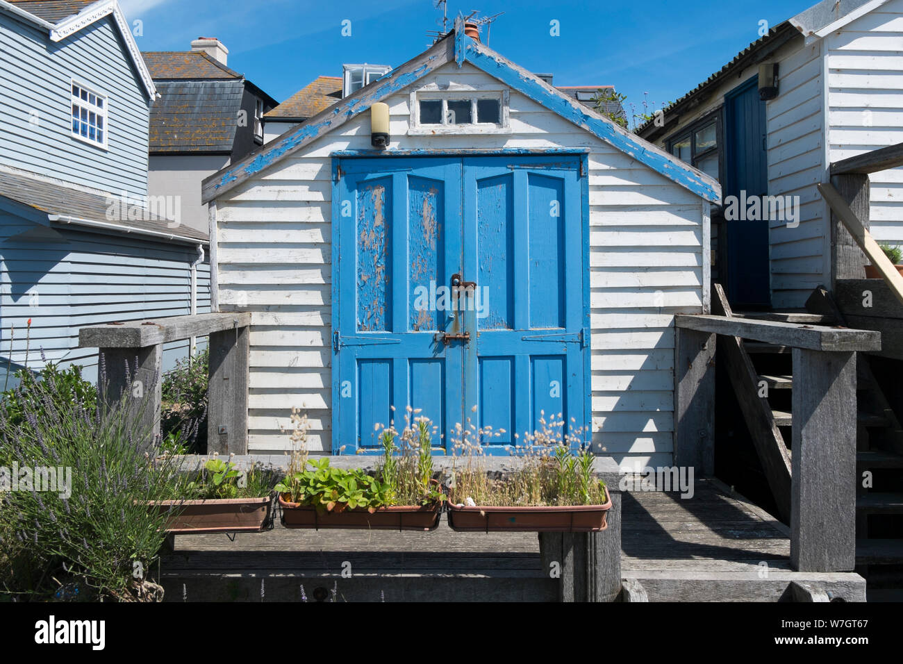 Traditional weatherboard houses and huts along the beach at Whitstable ...