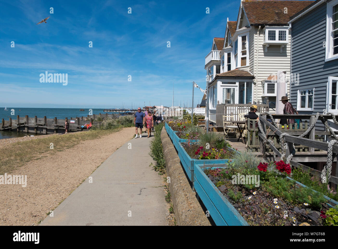 Traditional weatherboard houses and huts along the beach at Whitstable ...