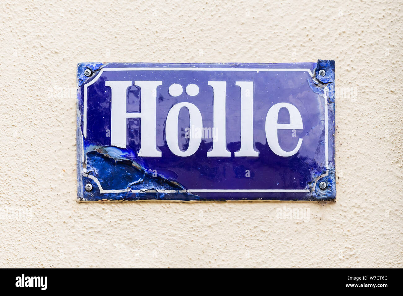 picture of a street name sign with the name Hoelle, that ist the German ...