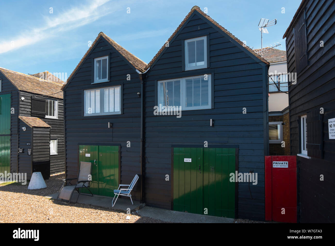 Traditional weatherboard houses and huts along the beach at Whitstable ...