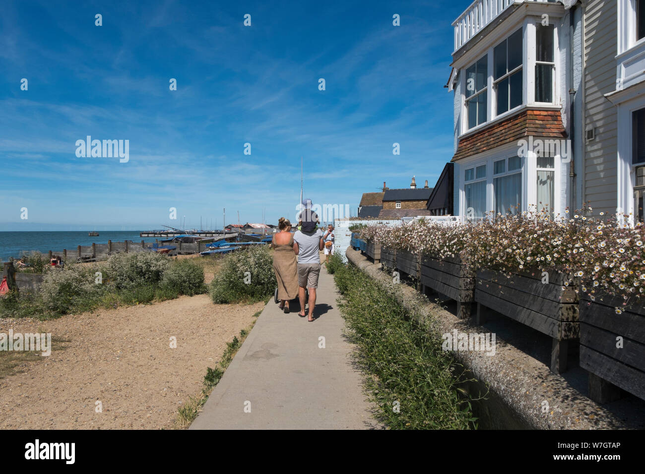 Traditional weatherboard houses and huts along the beach at Whitstable ...