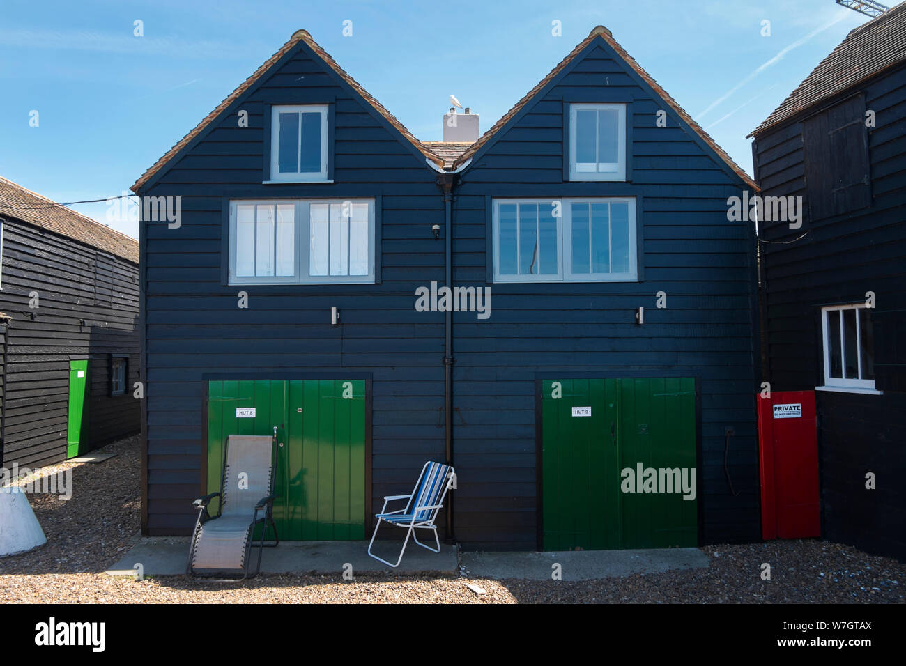 Traditional weatherboard houses and huts along the beach at Whitstable ...