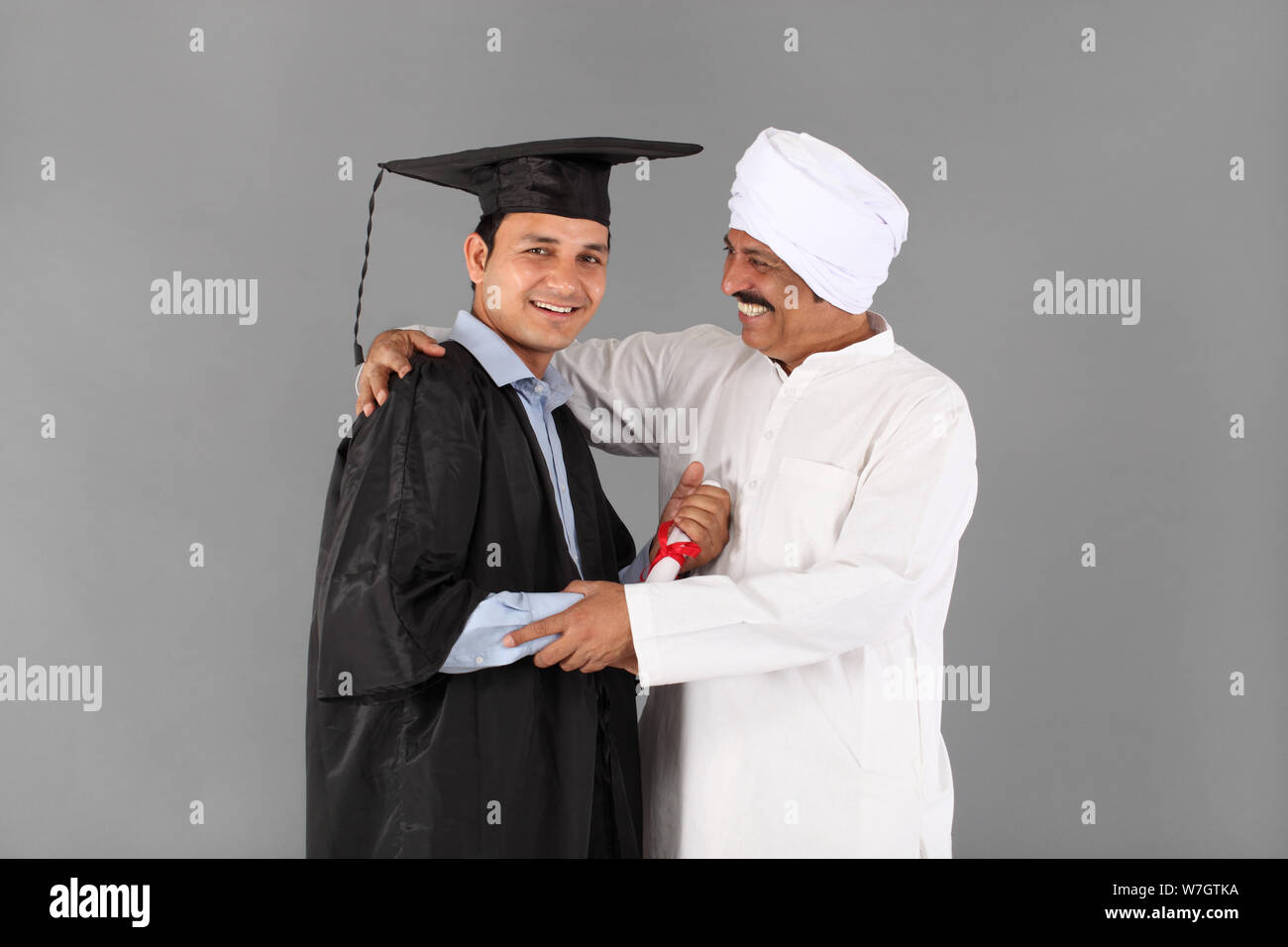 Male graduate with his father Stock Photo - Alamy