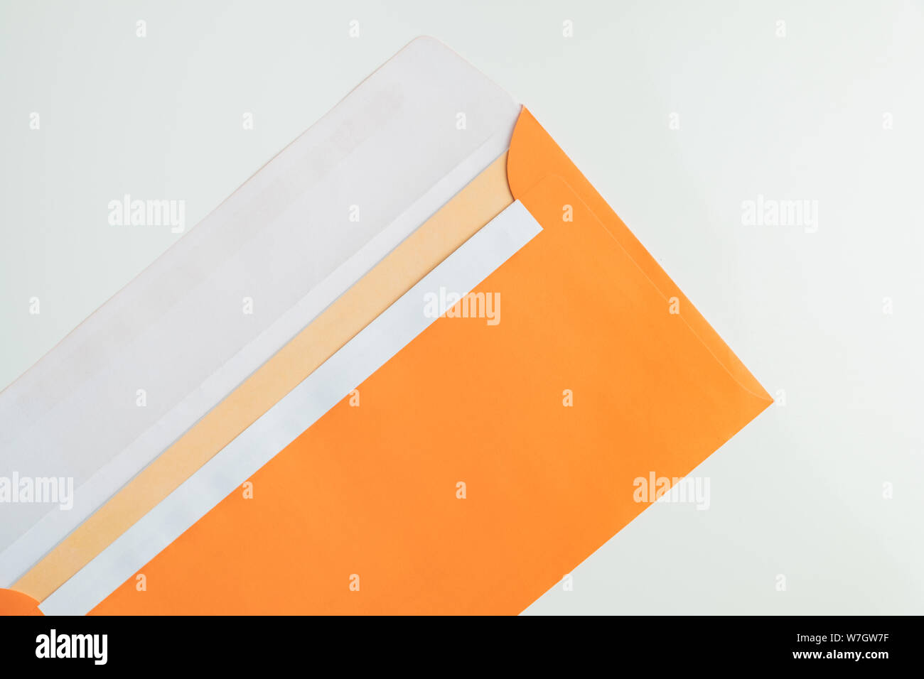Open envelope in white background, top view. Abstract image of postal ...