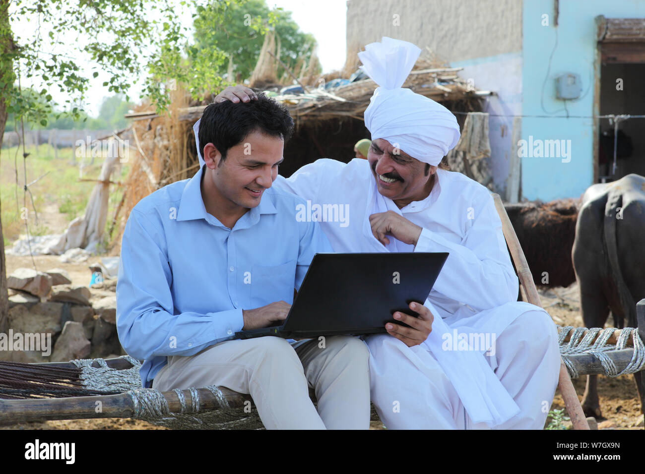 Man working on laptop and village hi-res stock photography and images ...