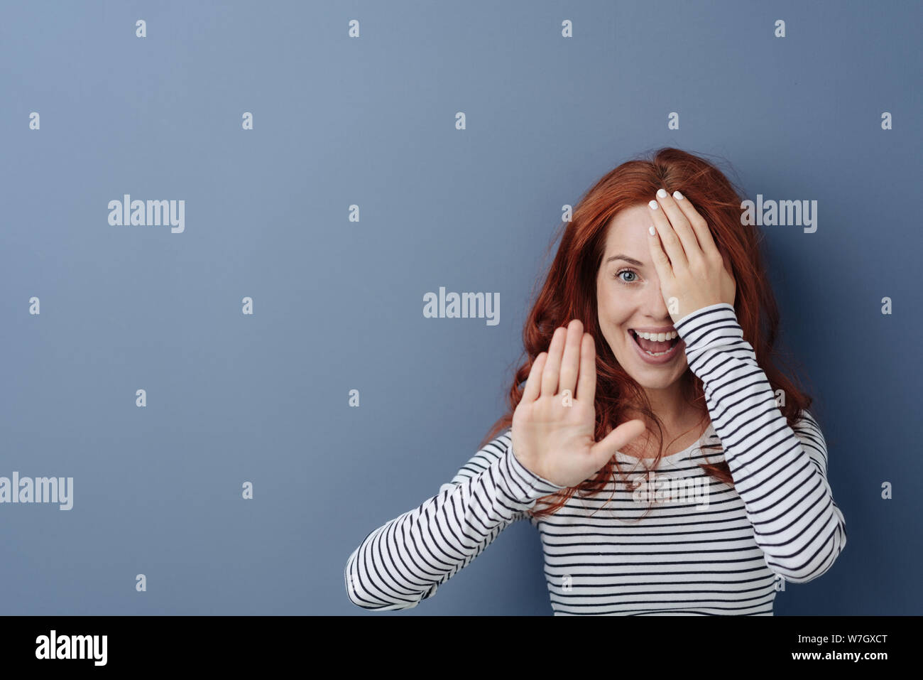 Hand over eyes peeking woman hi-res stock photography and images - Alamy
