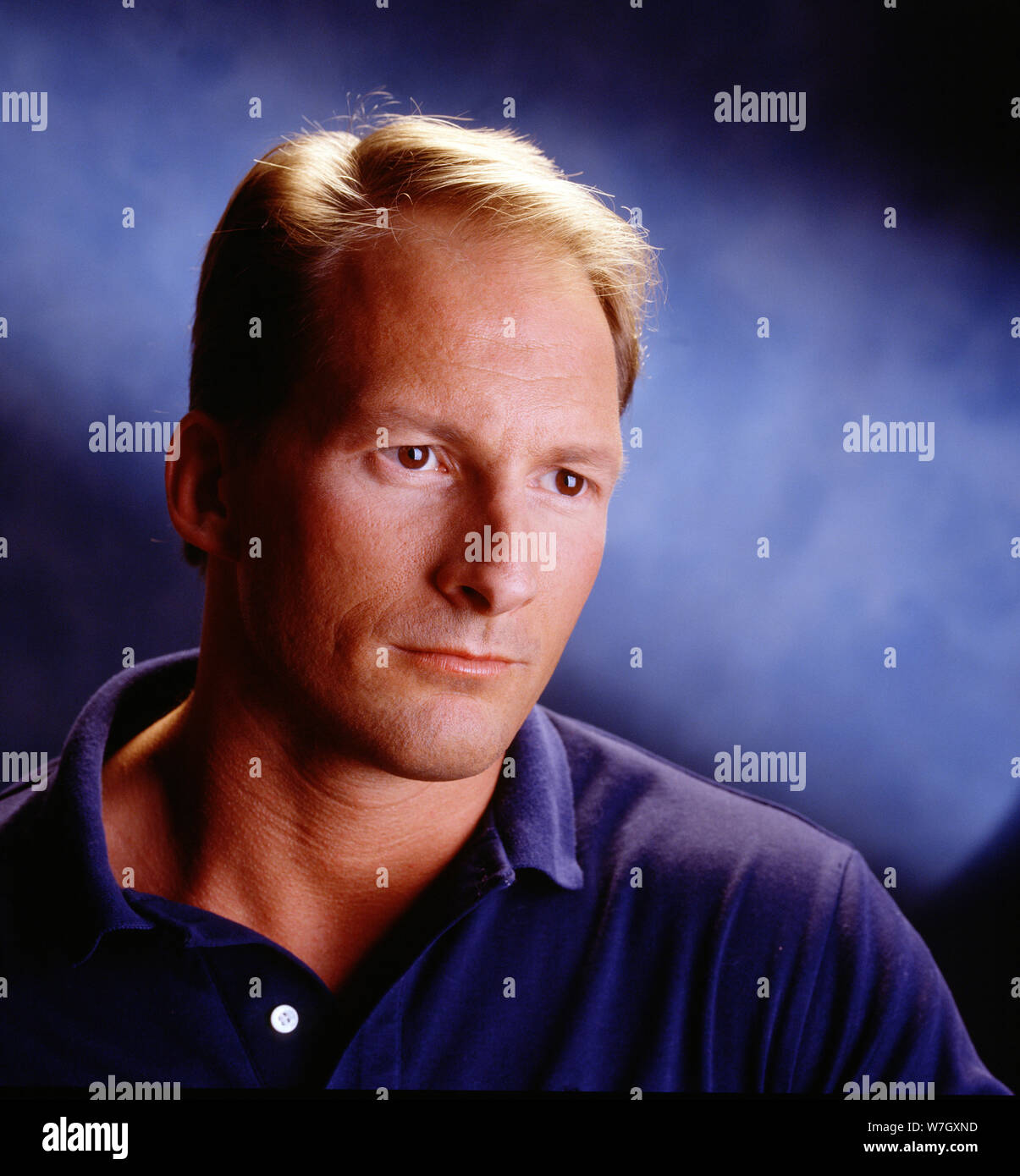 Portrait of a man with blond hair looking very solemn Stock Photo - Alamy