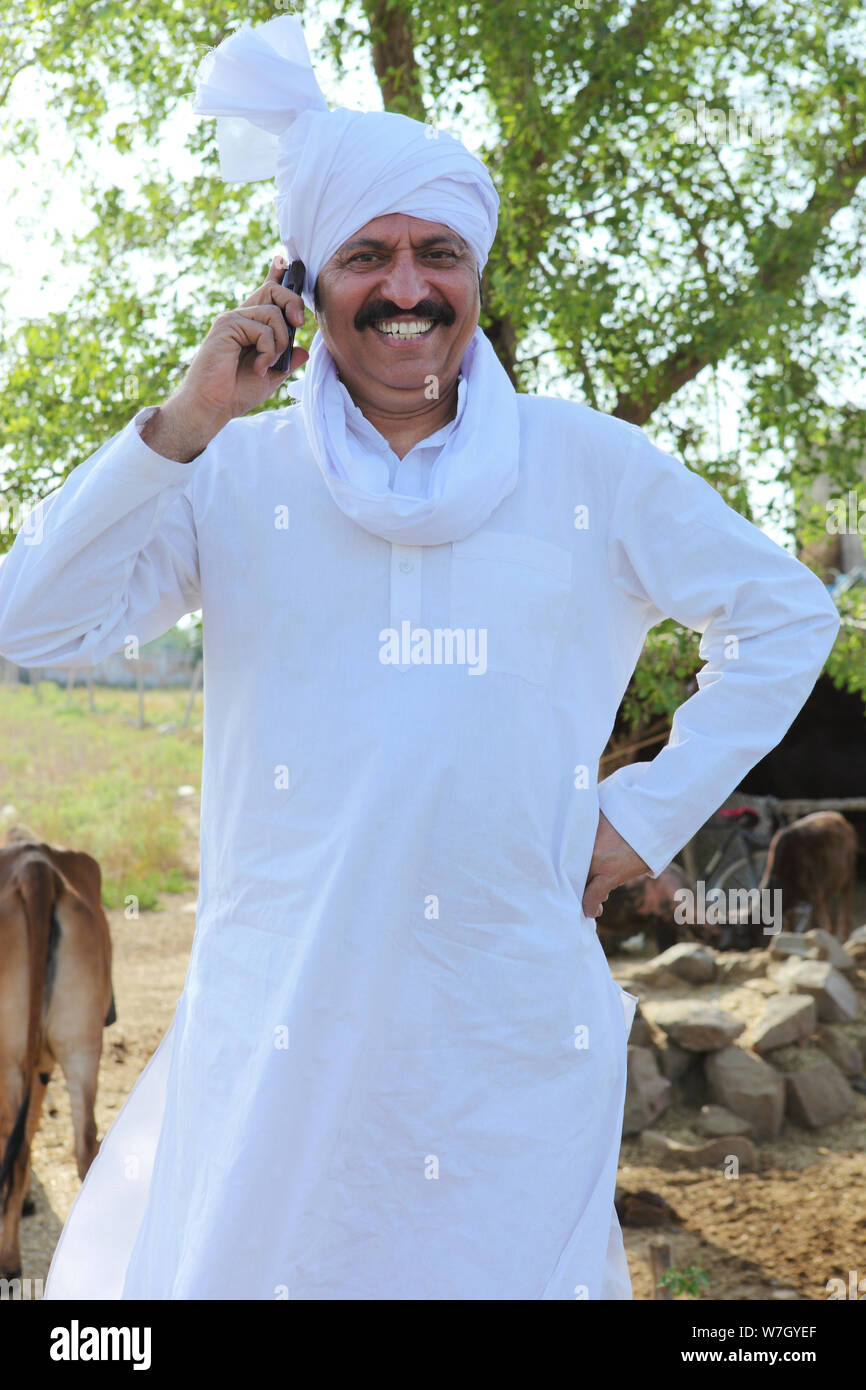 Rural man talking on mobile phone and smiling Stock Photo - Alamy
