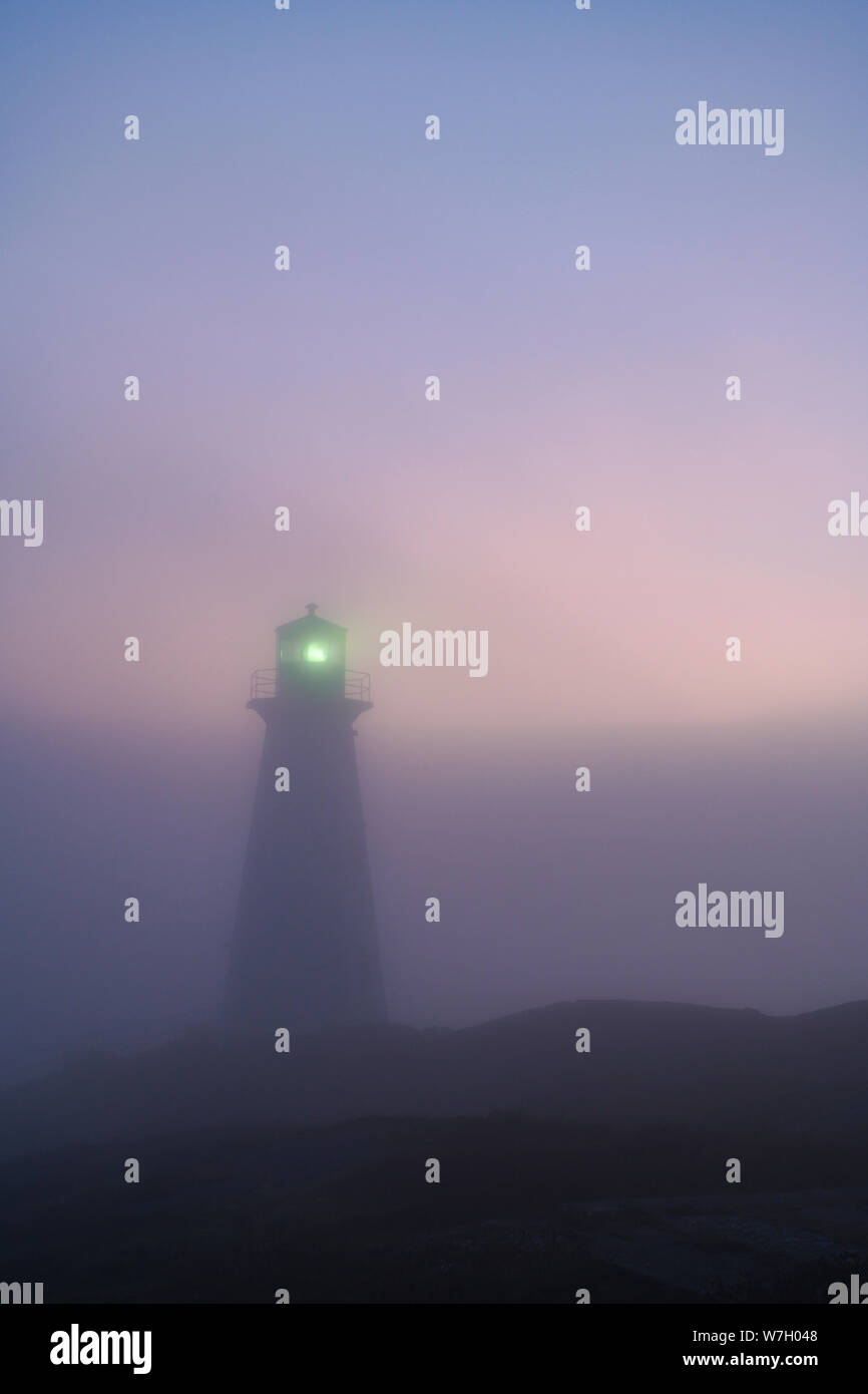 Cape Spear Lighthouse in early morning fog, St. John's, Newfoundland ...