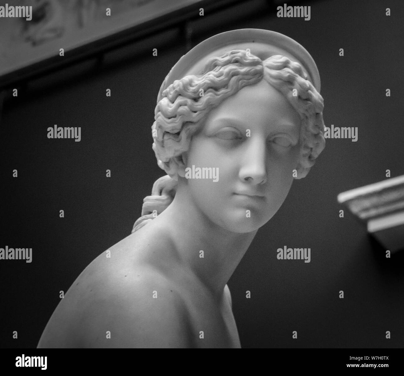 White marble head of young woman. Statue of a woman in the antique ...