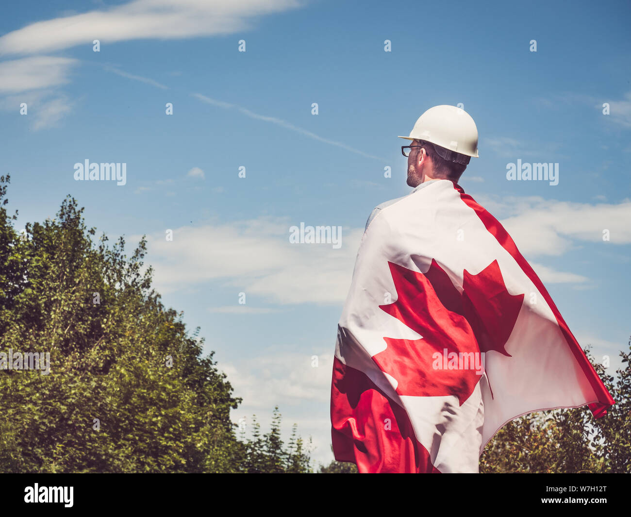 Engineer, holding Canadian Flag in the park Stock Photo - Alamy
