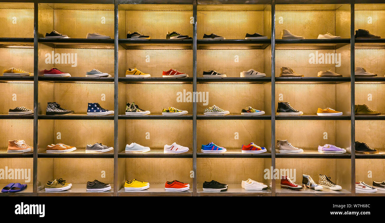 Lots of different sneakers on the showcase on market. Image of sport ...