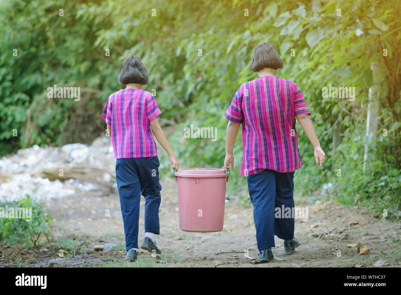 Female Students help to remove rubbish from the classroom to pile waste ...