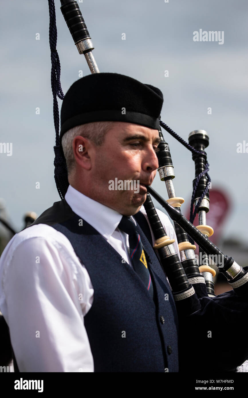 A single piper from the procession at the Halkirk Highland Games in ...