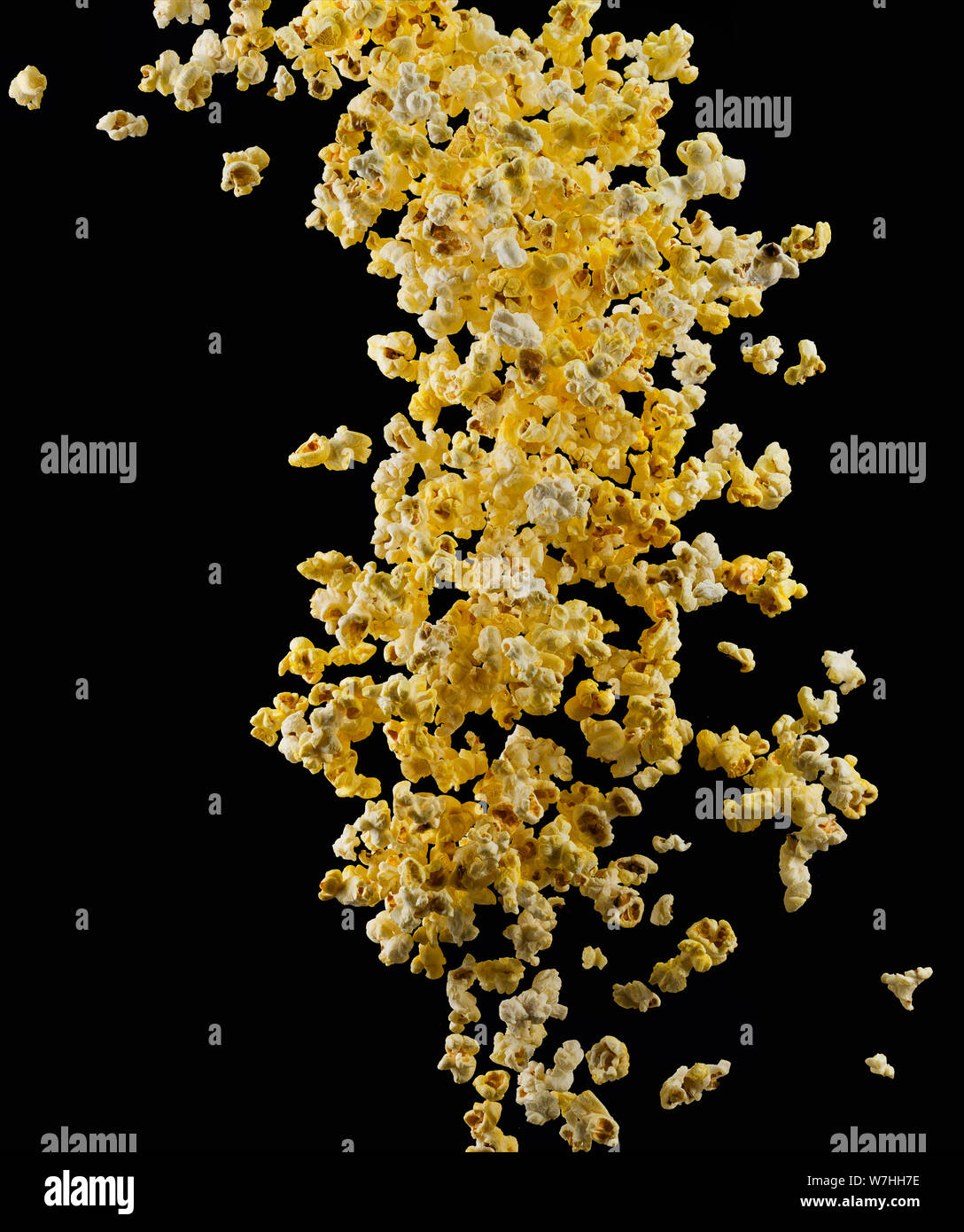 Flying popcorn or wave from it isolated on black background Stock Photo ...